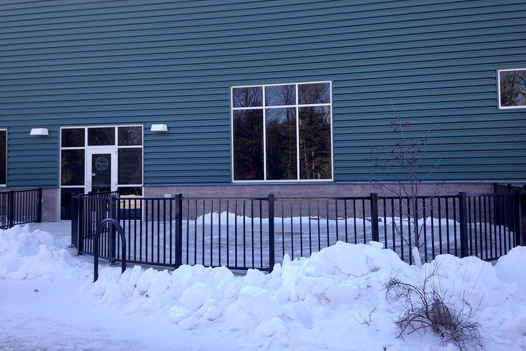Installing ornamental fence at Upper Hand Brewery Escanaba