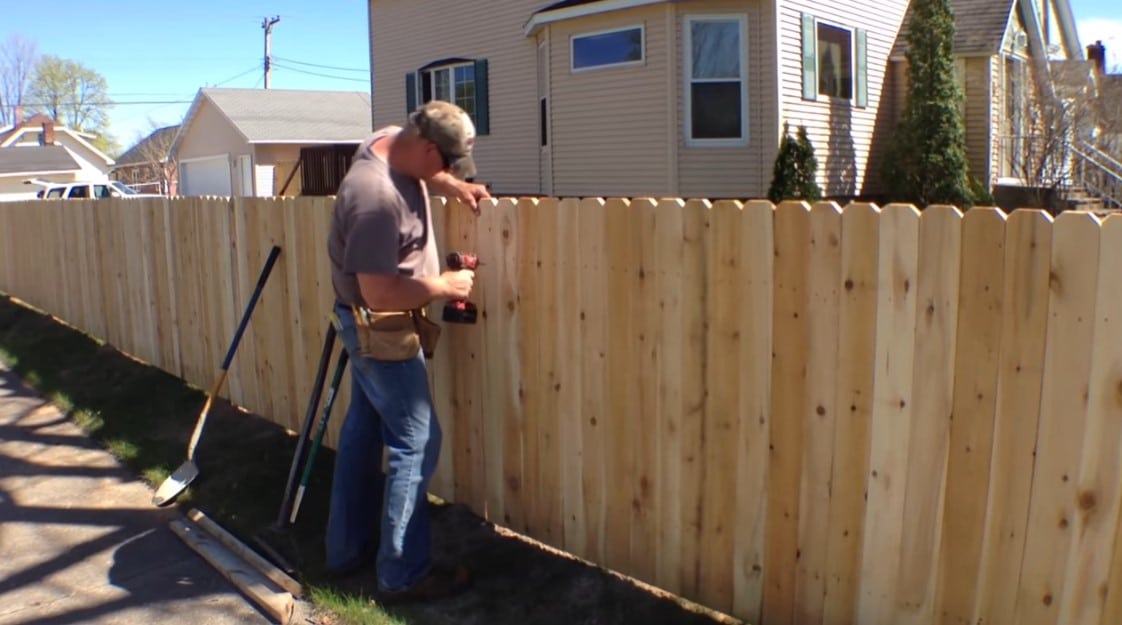 Installing wooden fence - Delta Fence & Construction